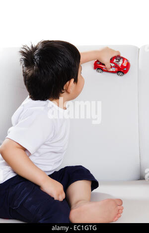 Kid's hand holding a toy car close-up Stock Photo - Alamy