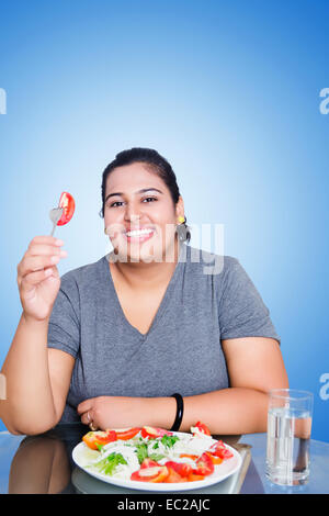 Fat woman sitting at table home Stock Photo - Alamy