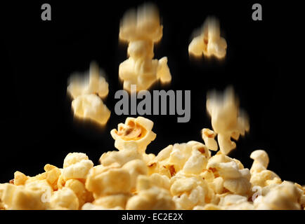 Popcorn falling down on black background Stock Photo - Alamy