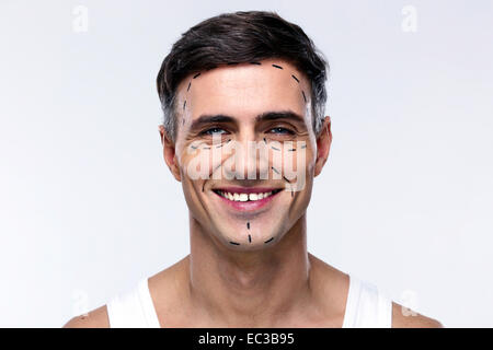 Smiling young man with marked face on green background, closeup ...