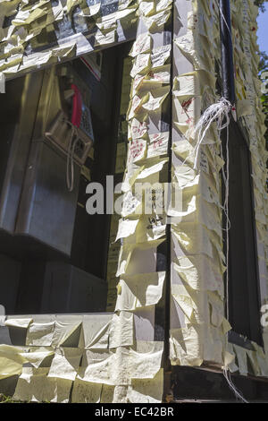 with sticky notes pasted phone booth in Berlin Stock Photo - Alamy