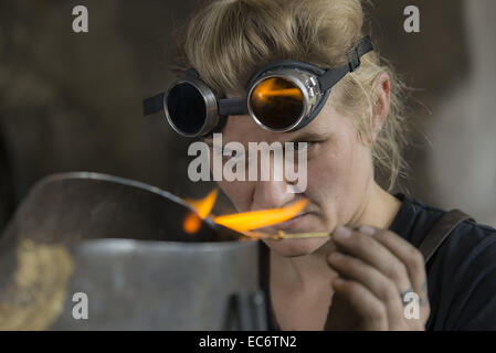 young female blacksmith with goggles, soldering metal Stock Photo - Alamy