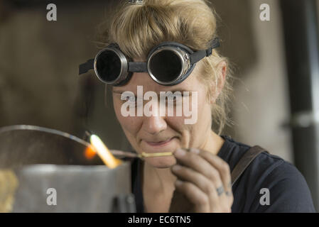 young female blacksmith with goggles, soldering metal Stock Photo - Alamy