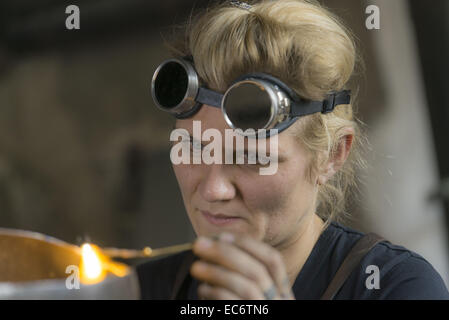 young female blacksmith with goggles, soldering metal Stock Photo - Alamy
