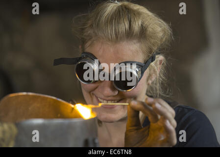 young female blacksmith with goggles, soldering metal Stock Photo - Alamy