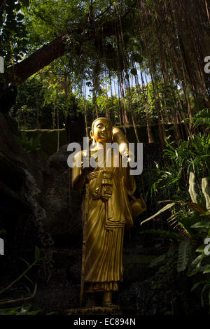Gold Phra Sivali or Phra Sivalee Buddhist Monk Statue standing front of ...