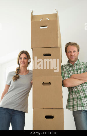 Young pair moving in to new house with boxes Stock Photo - Alamy