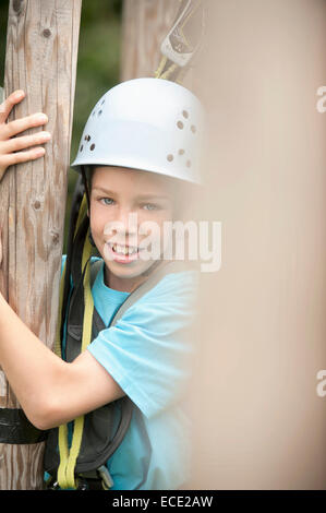 Portrait of boy climbing crag, smiling Stock Photo - Alamy