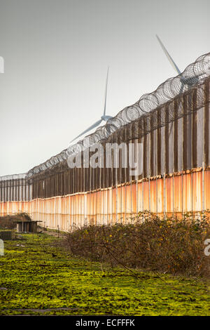 Wind turbine just over the wall of Haverigg Prison, Cumbria, UK Stock ...