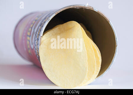 open tub of Pringles Original with contents spilled on white background ...