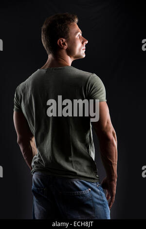 Back view portrait of a muscular handsome man pulling up at gym Stock ...
