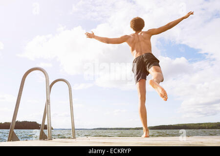 This is an image of a young man diving into the water Stock Photo - Alamy