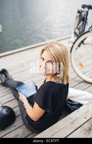 Smiling businesswoman using digital tablet in office Stock Photo - Alamy