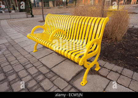 yellow painted metal bench in public park Stock Photo - Alamy