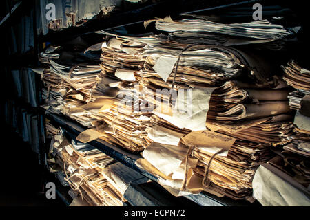 Paper documents stacked in archive on shelf Stock Photo - Alamy