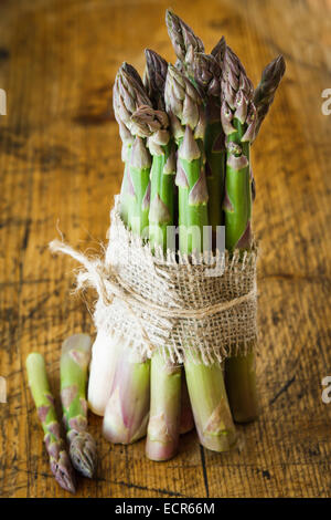 Fresh green asparagus on old oak table Stock Photo - Alamy