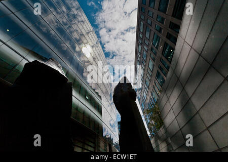 Abstract reflections of buildings in the curved green glass façade of ...