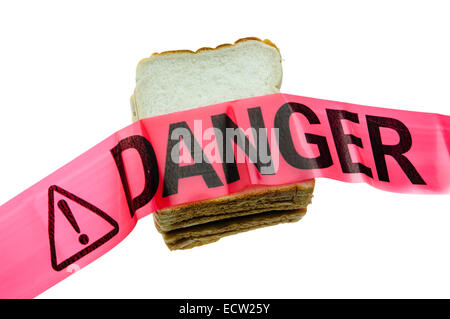Gluten intolerance with bread wheat and warning sign on white planks ...