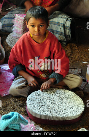 2010. Child worker at a hand rolled cigarette (locally called a bidi ...