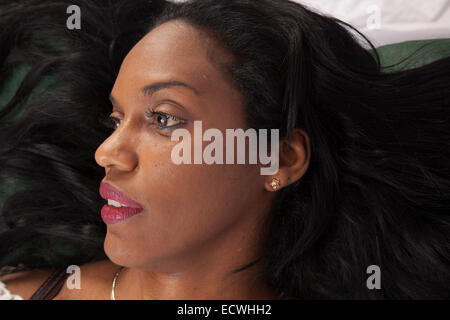 Pretty black woman reclining with a thoughtful expression Stock Photo ...