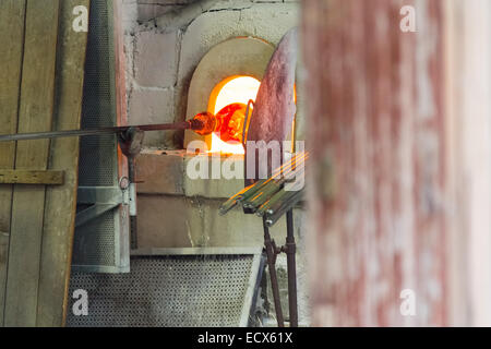 Manufacturing glass in a traditional oven, in glass factory in Murano ...