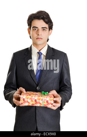Business executives giving birthday gifts to a colleague in Office ...