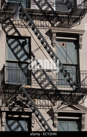 Fire escape ladders and century old apartment building built in stone ...
