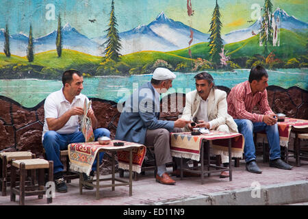 Turkish and Kurdish men having tea at a sidewalk cafe in the city Van ...