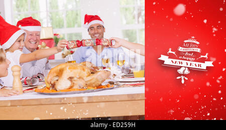 Composite image of siblings pulling a christmas cracker Stock Photo - Alamy