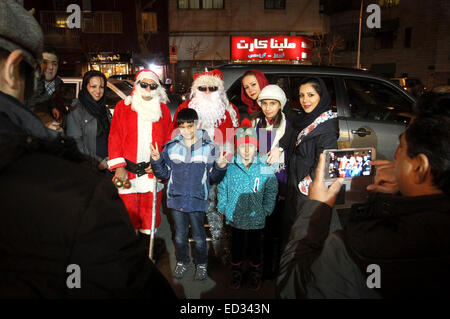 Tehran, Iran. 24th Dec, 2014. People select Santa Claus-shaped ...