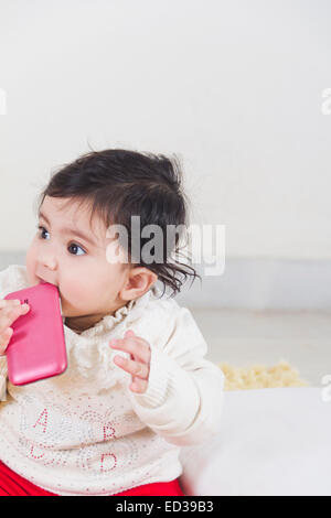 Baby girl playing at indoor kids kitchen playground Stock Photo - Alamy