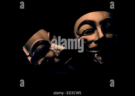 white and yellow anonymous masks on wood background - retro style Stock ...