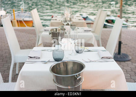 Elegant outdoor wedding dinner table setting with crystal glassware ...
