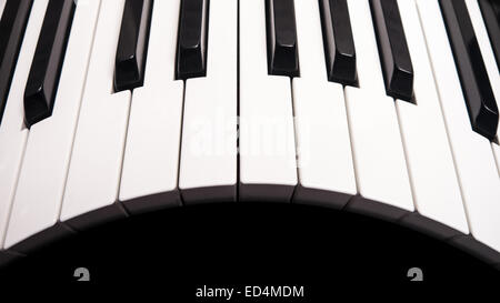 curved piano keys, abstract photo with black background Stock Photo - Alamy