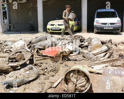 People and rescue workers try to salvage what they can from the ...