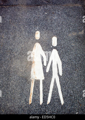 Pedestrian pavement symbol with adult and child icon on urban sidewalk ...