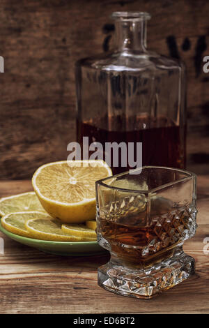 seasoned brandy into the glasses and decanter vintage style Stock Photo ...