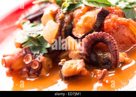 Stewed in tomato sauce Octopus with seafood and croutons Stock Photo ...