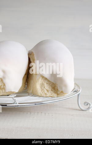 Iced buns or fingers a cake made from a bread roll covered with icing ...