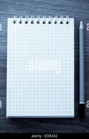pencil on checked notebook on wood background Stock Photo - Alamy