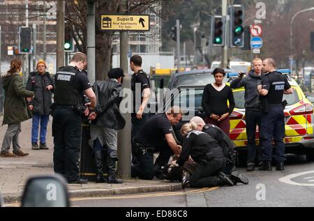 A woman is restrained and arrested by police for being drunk and ...