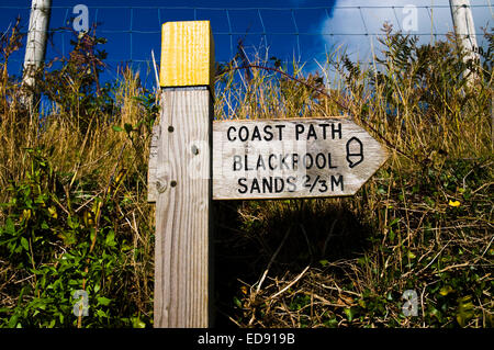 A wooden sign post to guide walkers along a trail within Norsey Woods ...
