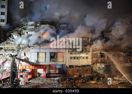 Firefighters and rescuers work at the site of a fire at an elementary ...