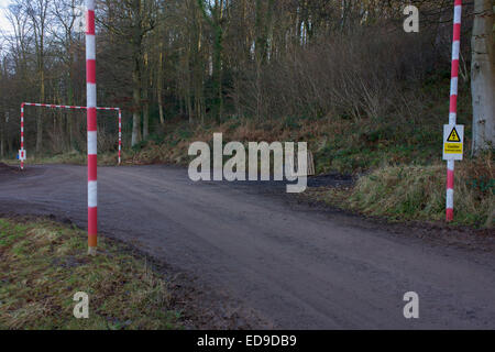 Height restriction caution sign and poles in a north Somerset woodland ...