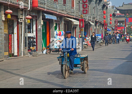 Chinese man riding a bicycle cart in Guilin China Stock Photo - Alamy