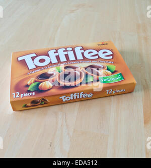Box of Toffifee hazelnut and caramel candy cups topped with chocolate ...