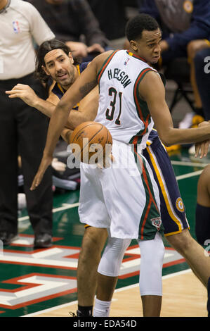 Milwaukee Bucks forward John Henson, left, shoots over Minnesota ...