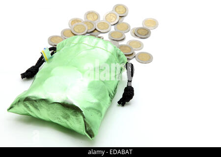 full coins spilling out from green money bag or purse isolated on white ...