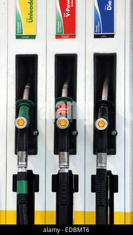 Royal Dutch Shell petrol pumps in their rests at a petrol station in ...
