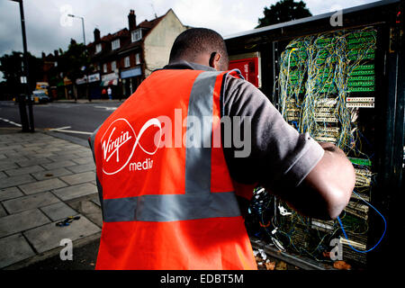 A Virgin Media engineer connecting a house to the Virgin telephone ...